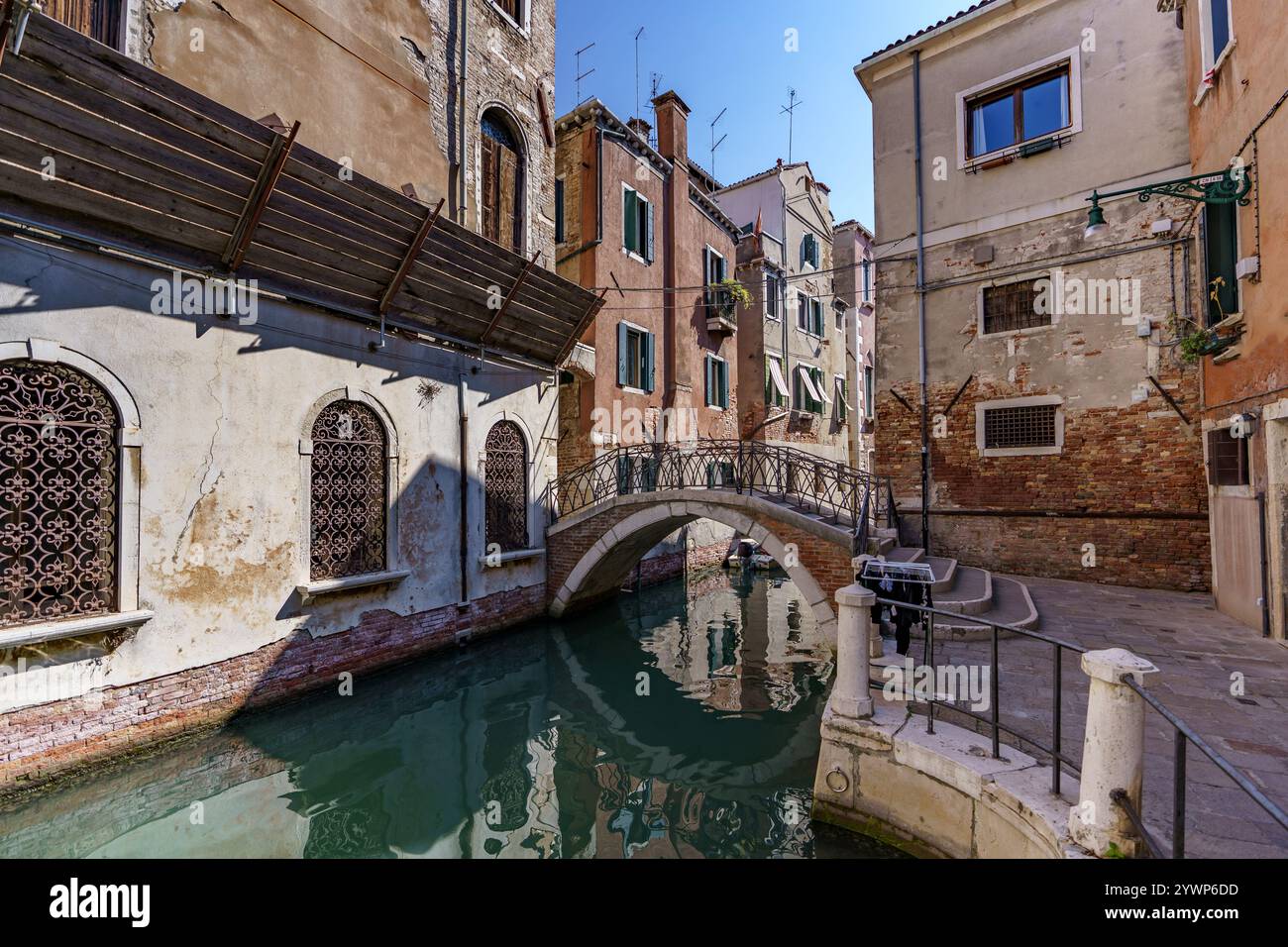 A view of the narrow Venetian water channels winding tightly between ...