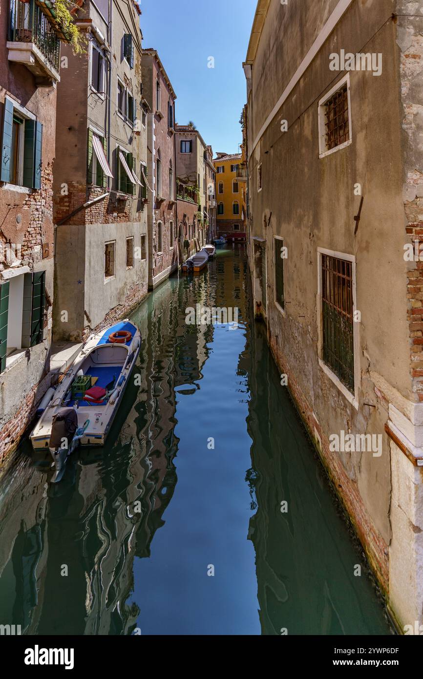 A view of the narrow Venetian water channels winding tightly between ...
