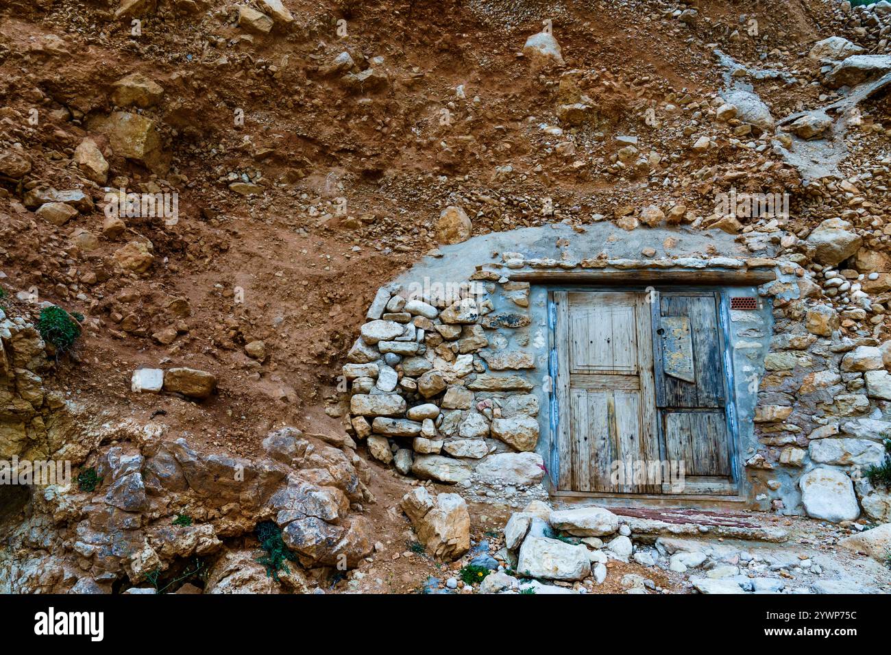 An old door closing a hidden entrance to the inside of the rock Stock ...