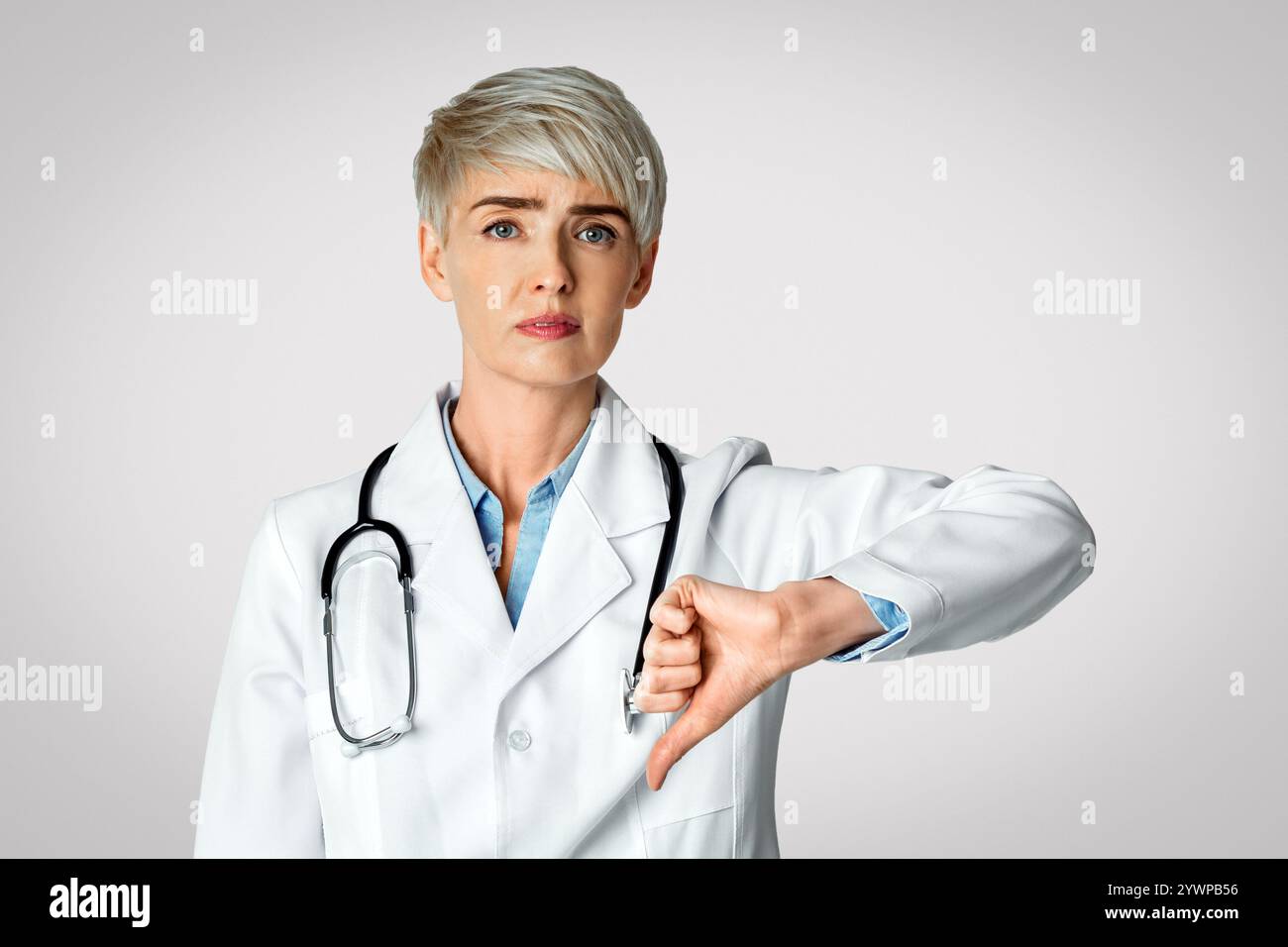Sad woman doctor shows with hand dislike Stock Photo - Alamy