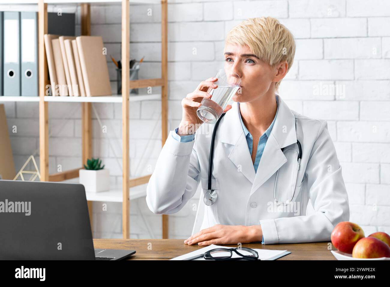 Woman doctor holds glass water hi-res stock photography and images - Alamy