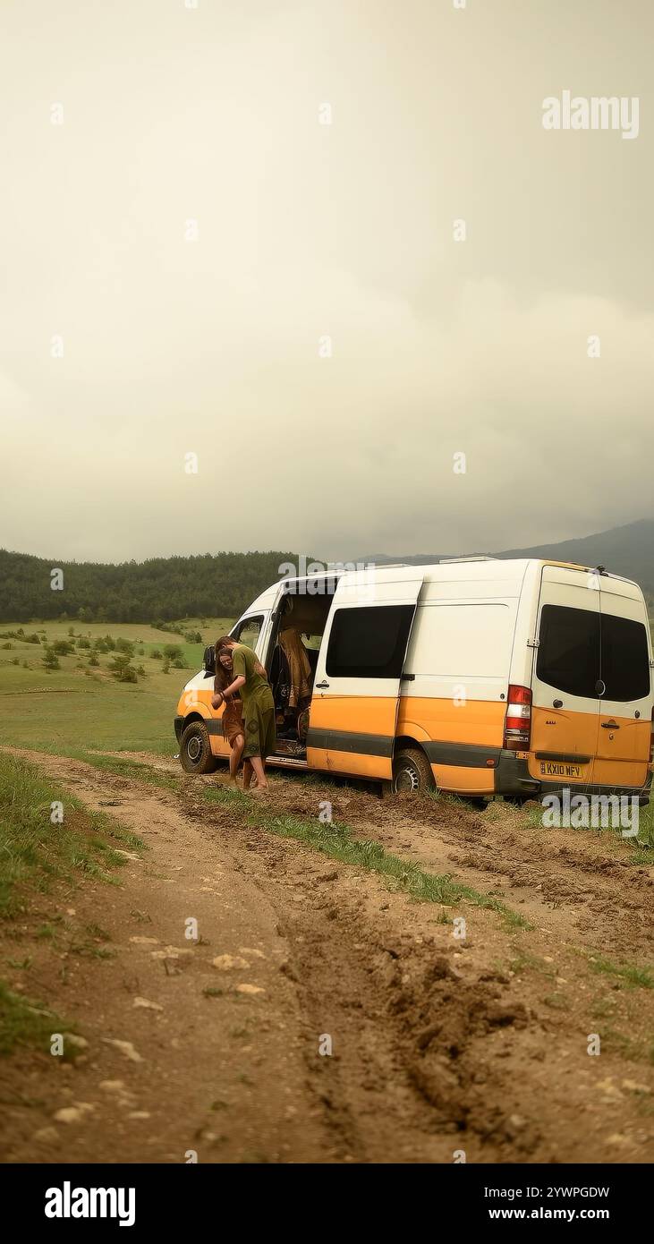 van crashed in the mud couple playing in the mud Stock Photo - Alamy