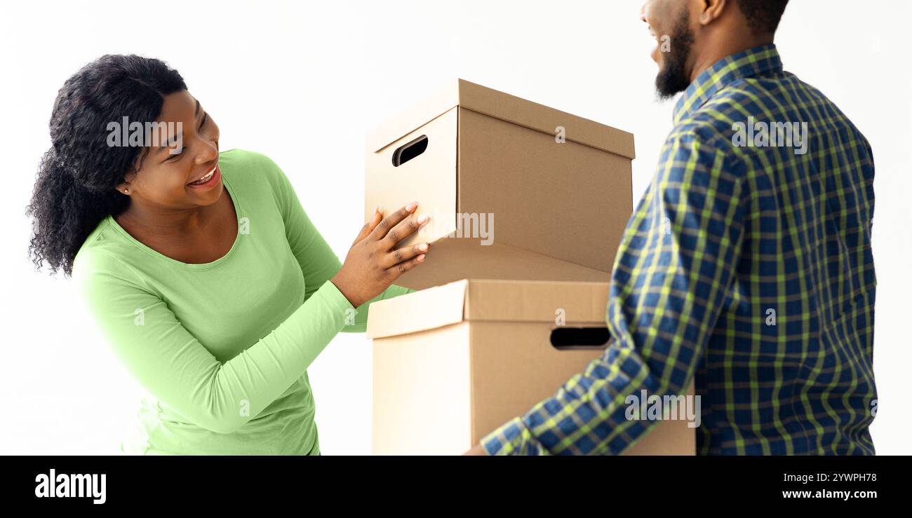 Moving Day. Portrait Of Joyful Young Black Spouses With Cardboard Boxes ...