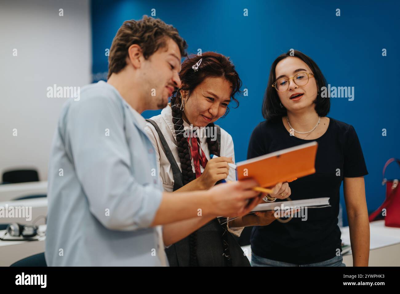 Students collaborating on a project in a classroom setting Stock Photo - Alamy