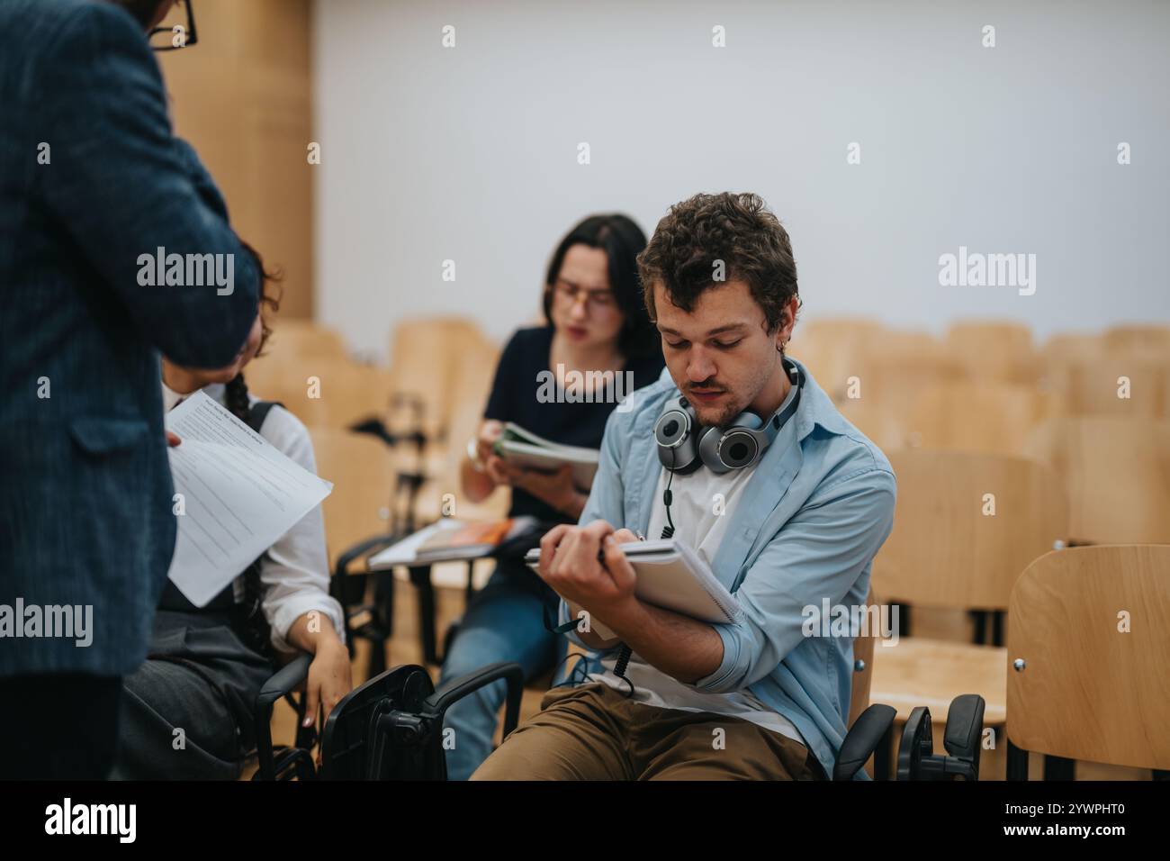 Group of students consulting with their professor in a classroom ...