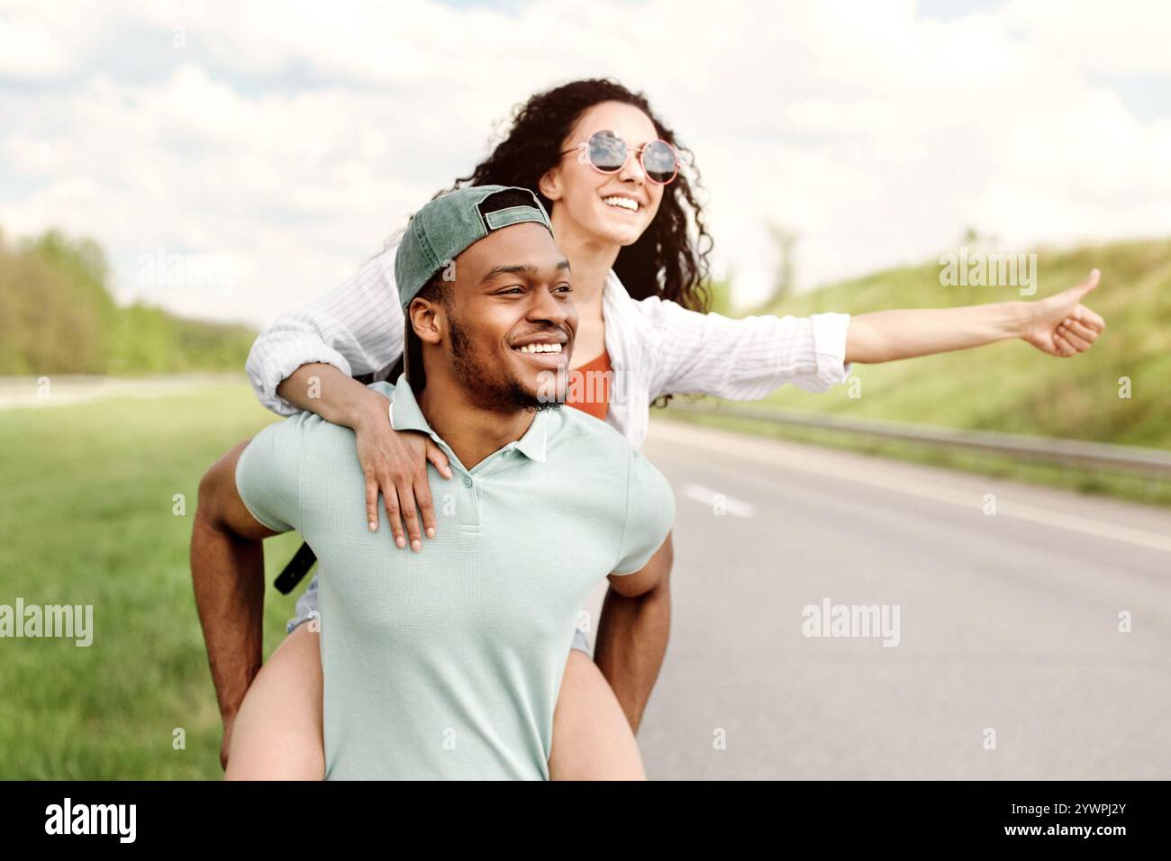 Cool black guy giving his girlfriend piggyback ride on road ...