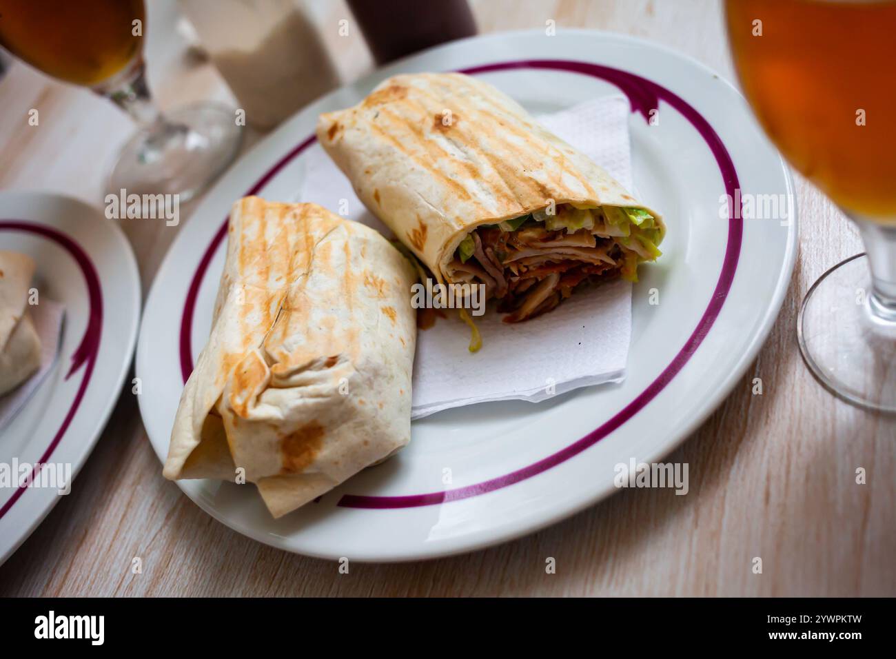 Cut tasty shawarma with chopped vegetables and greens Stock Photo - Alamy