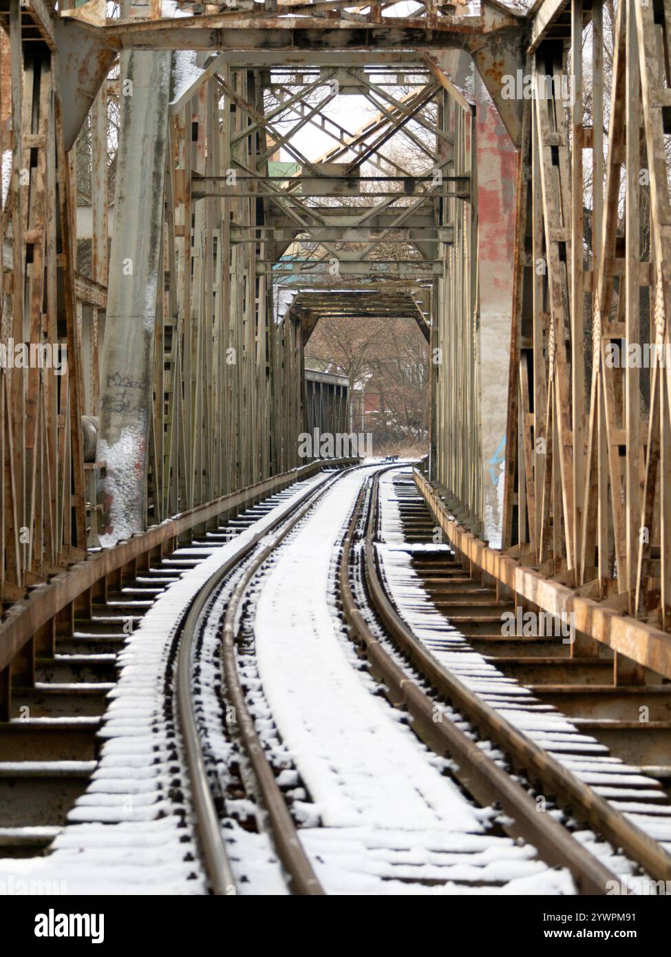 snow-covered railway tracks on an Old metal Bridge in Winter. steel ...