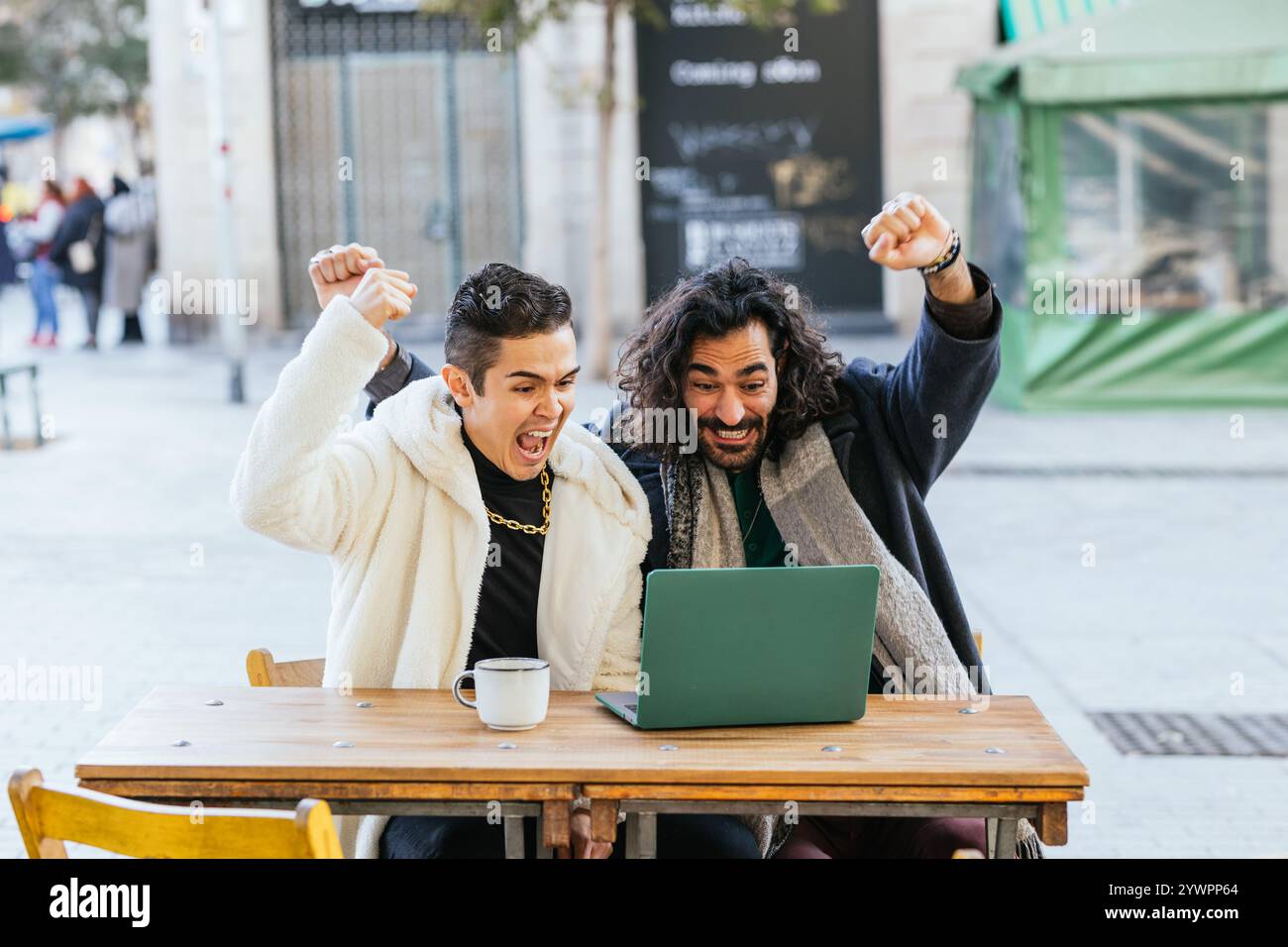 Gay couple celebrating using laptop hi-res stock photography and images ...
