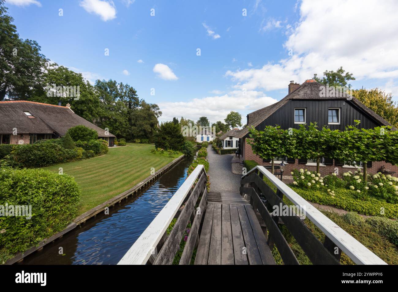Landscape view of famous Giethoorn village with canals and rustic thatched roof houses in farm ...