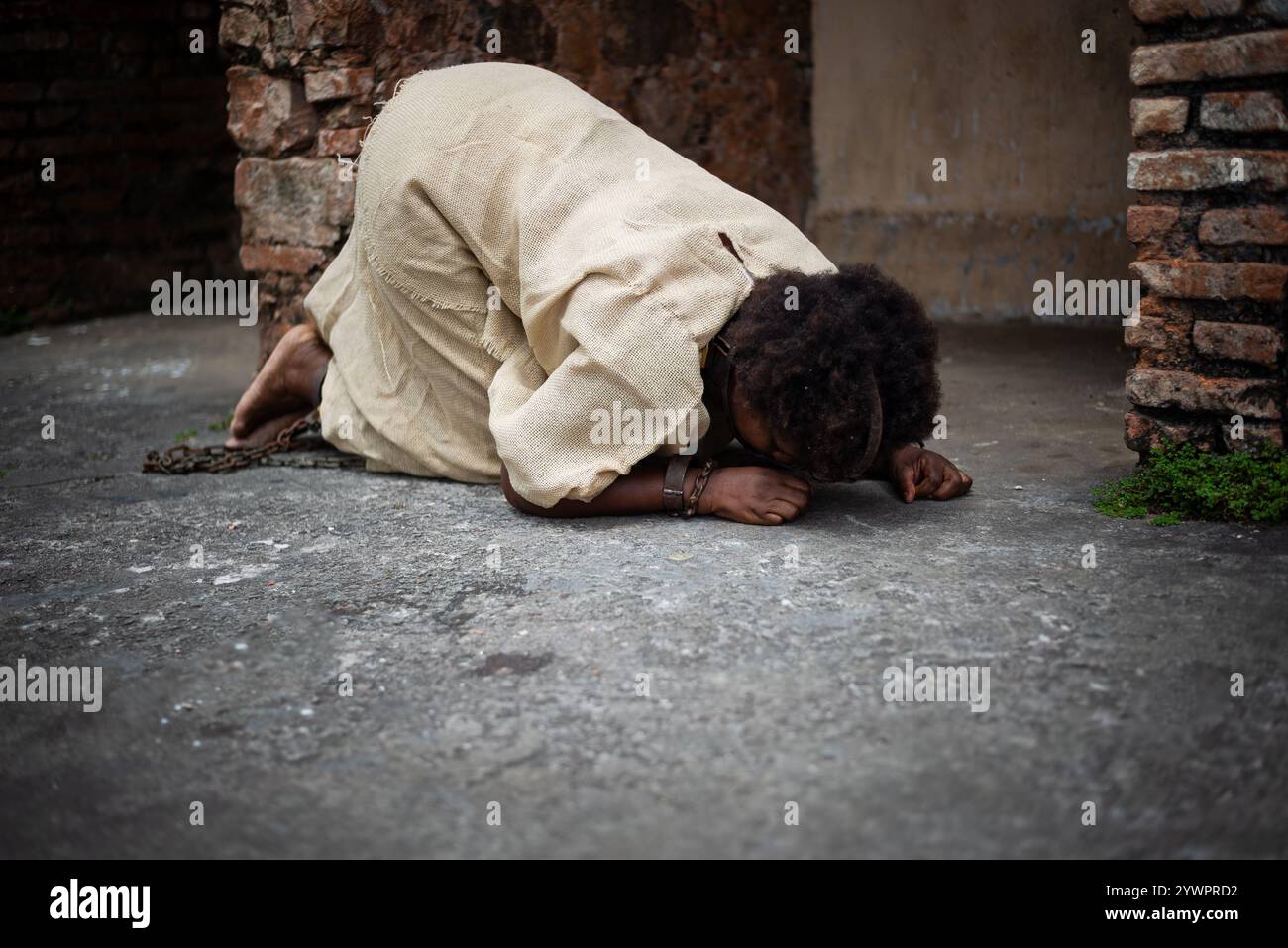 Portrait of a black woman in chains, with an iron mask over her mouth ...