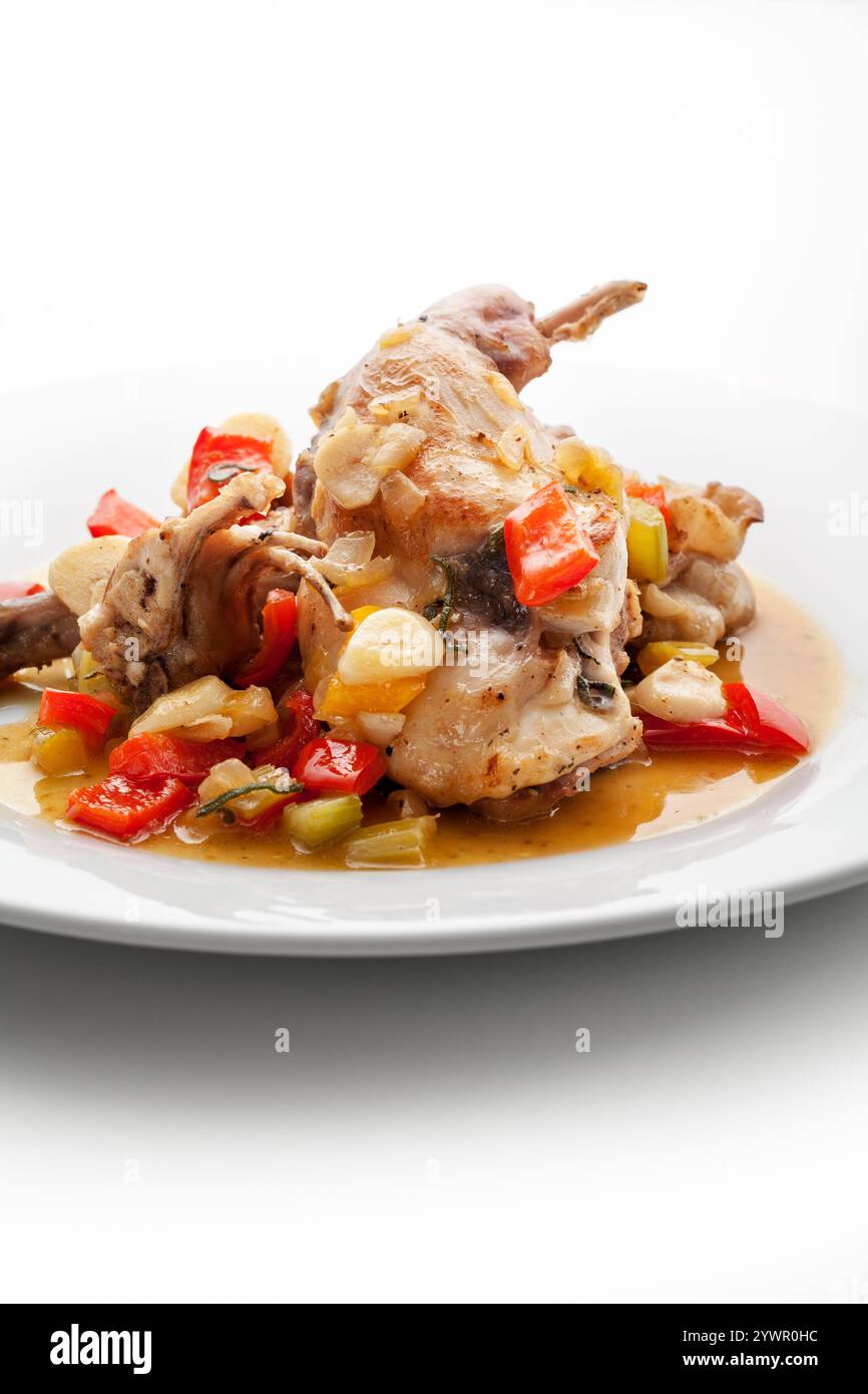 rabbit on vegetables with herbs Stock Photo - Alamy