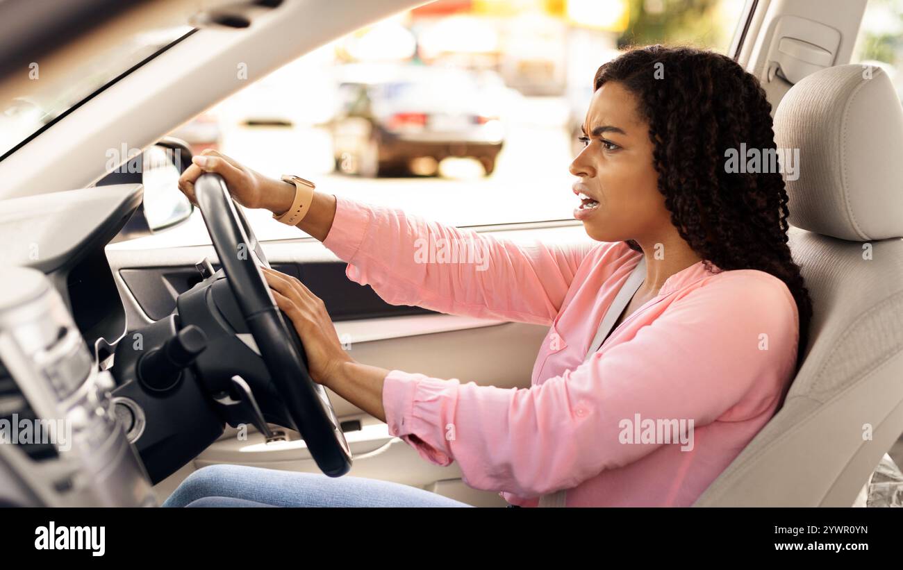 Angry black woman driving car shouting and honking Stock Photo - Alamy
