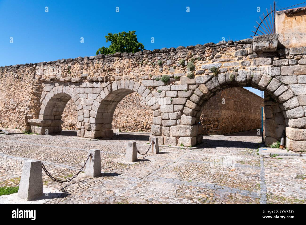 Ancient Roman aqueduct arches in Segovia, Spain, under a clear blue sky ...