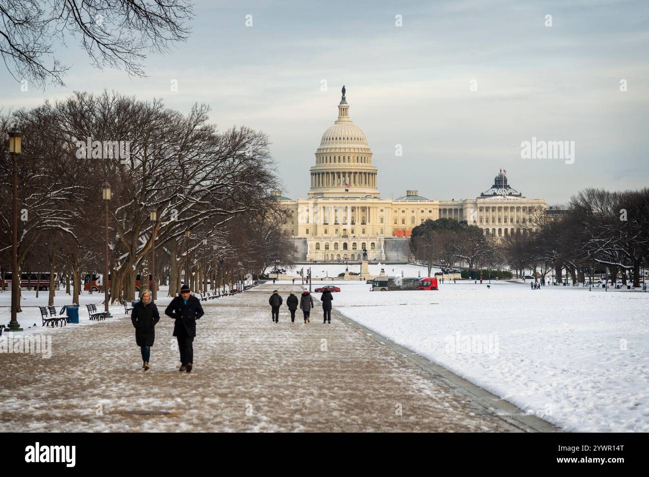 Pedestrians enjoy a snowy stroll along the National Mall with the ...