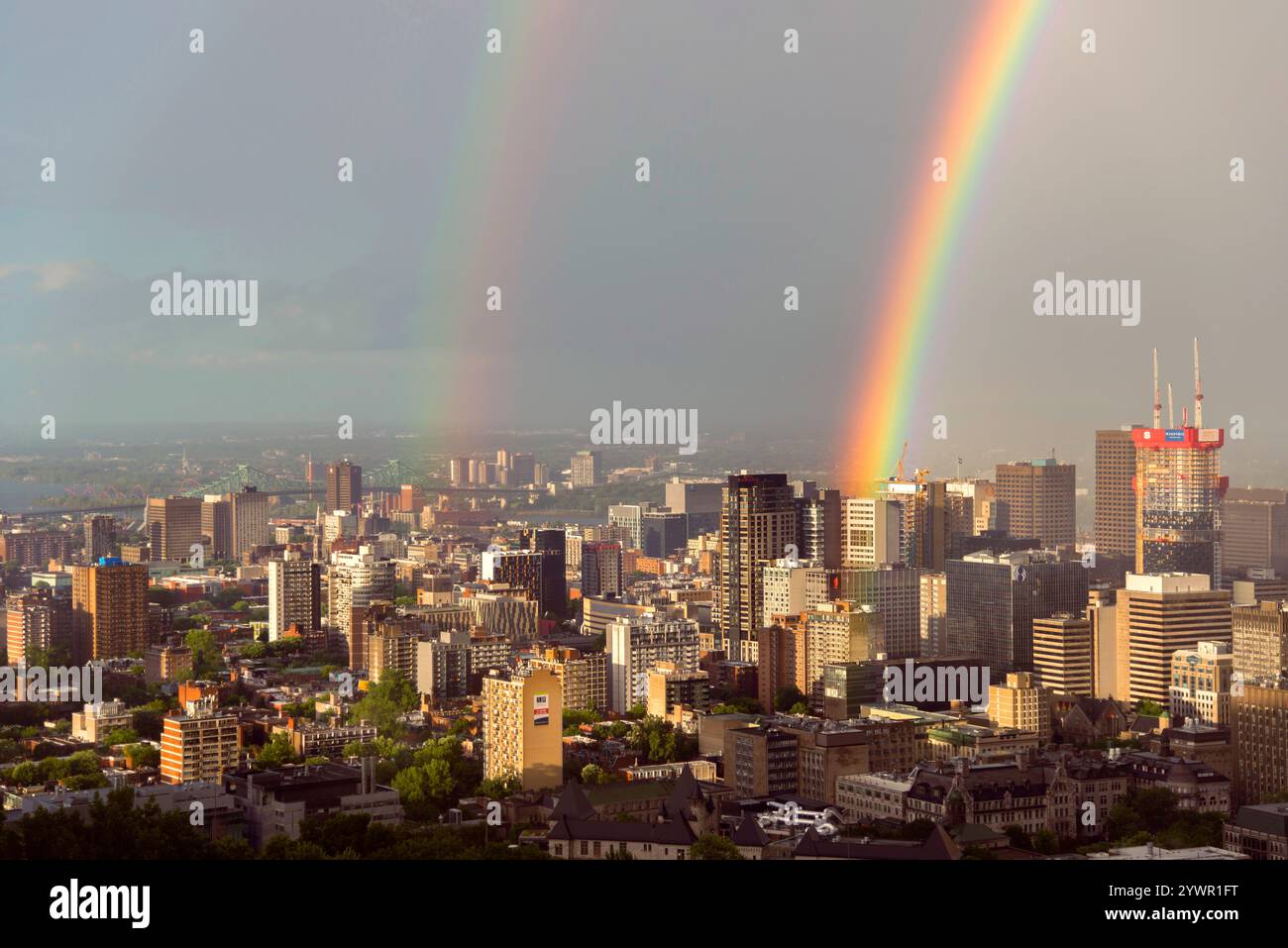 A vibrant double rainbow illuminates the skyline of Montreal, Quebec ...