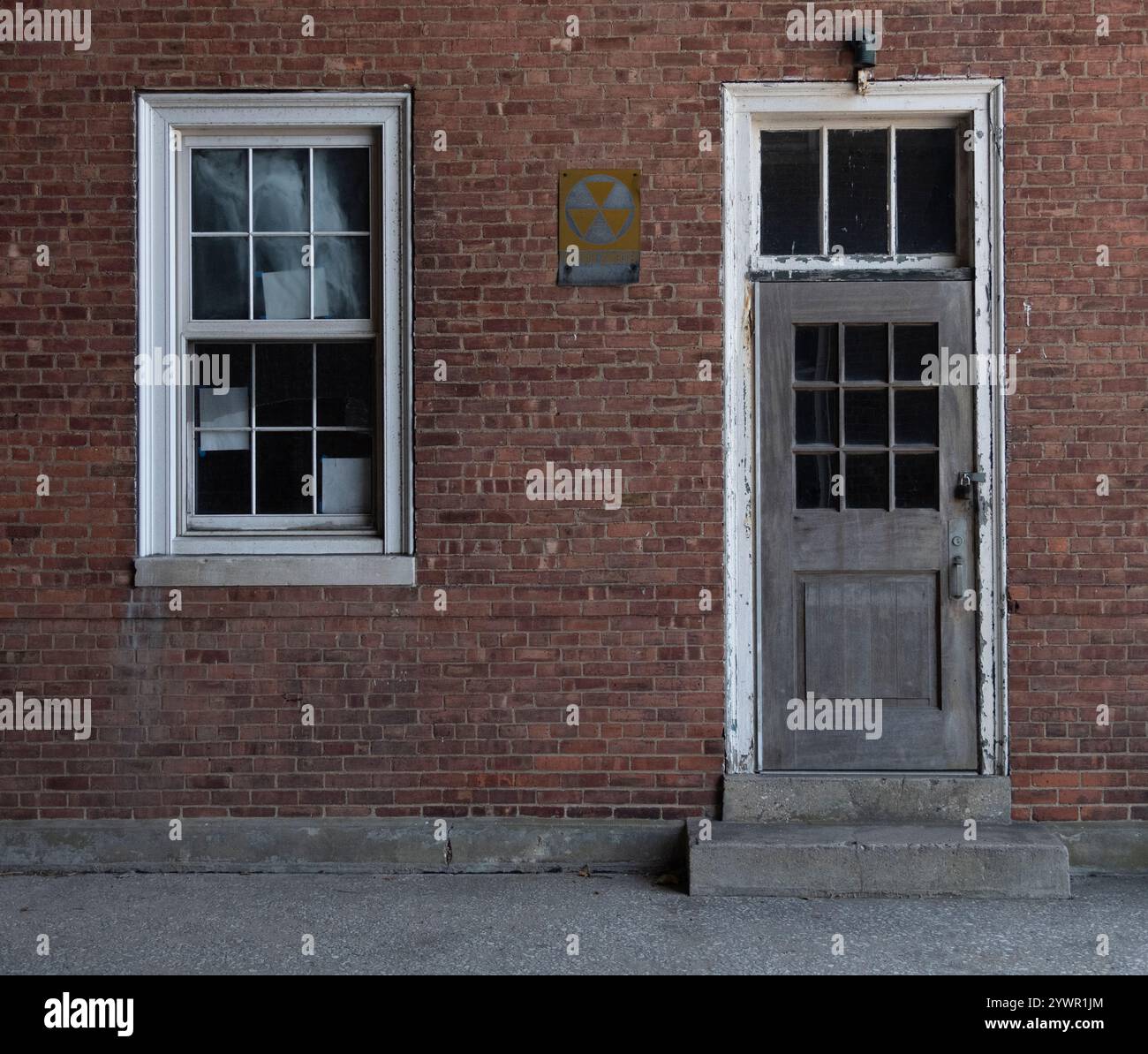 Exterior view of a red brick building with a vintage fallout shelter ...
