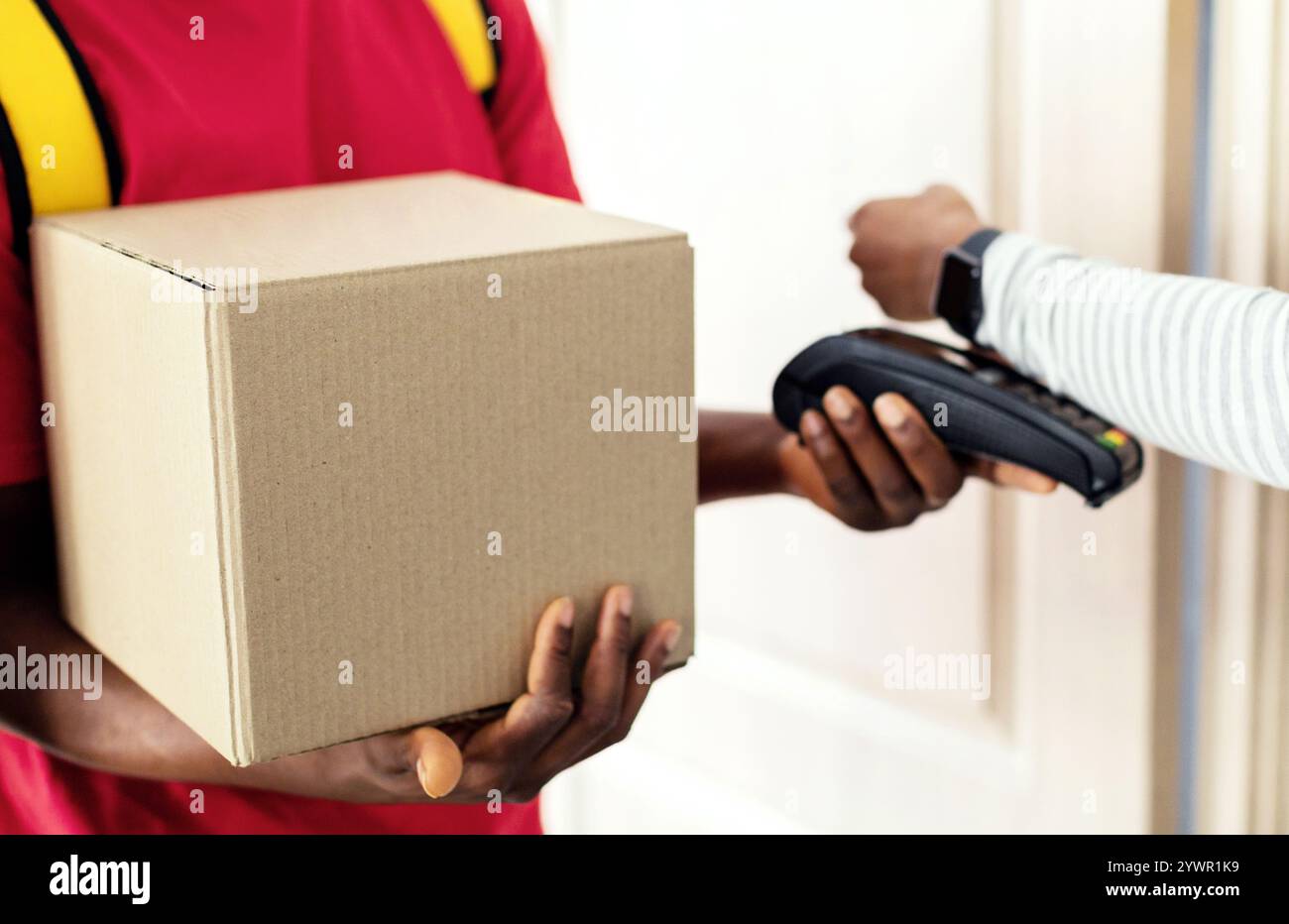 Lady Paying Courier For Parcel Delivery Using Smartwatch Indoor ...