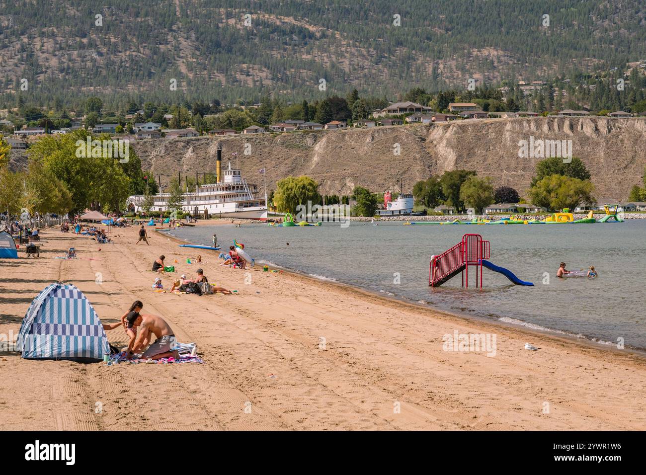 Penticton, BC, Canada-August 28, 2024: People at the beach on the shore ...