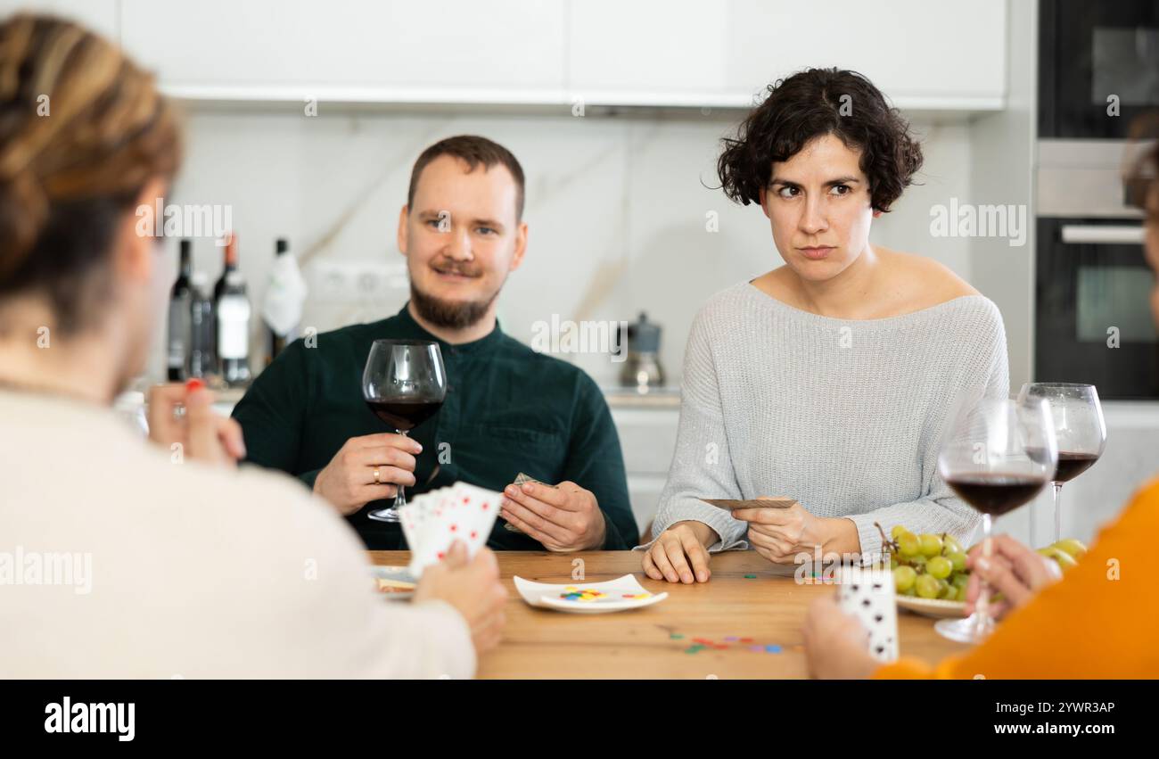 Two married couples playing card game poker Stock Photo - Alamy