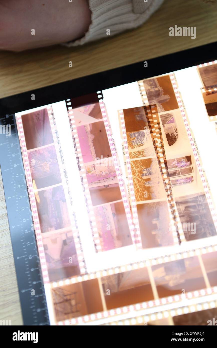 Teenage girl looking at 35mm film negatives on lightbox Stock Photo - Alamy