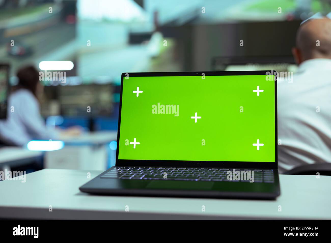 Laptop showing blank greenscreen display in a control center agency ...