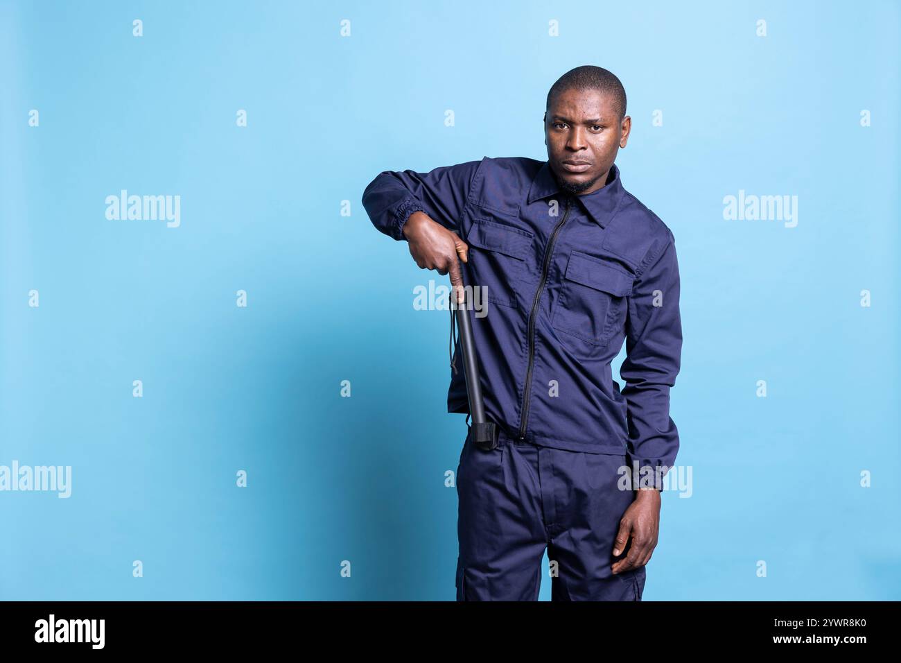 Security guard on duty taking out his weapon against blue background ...