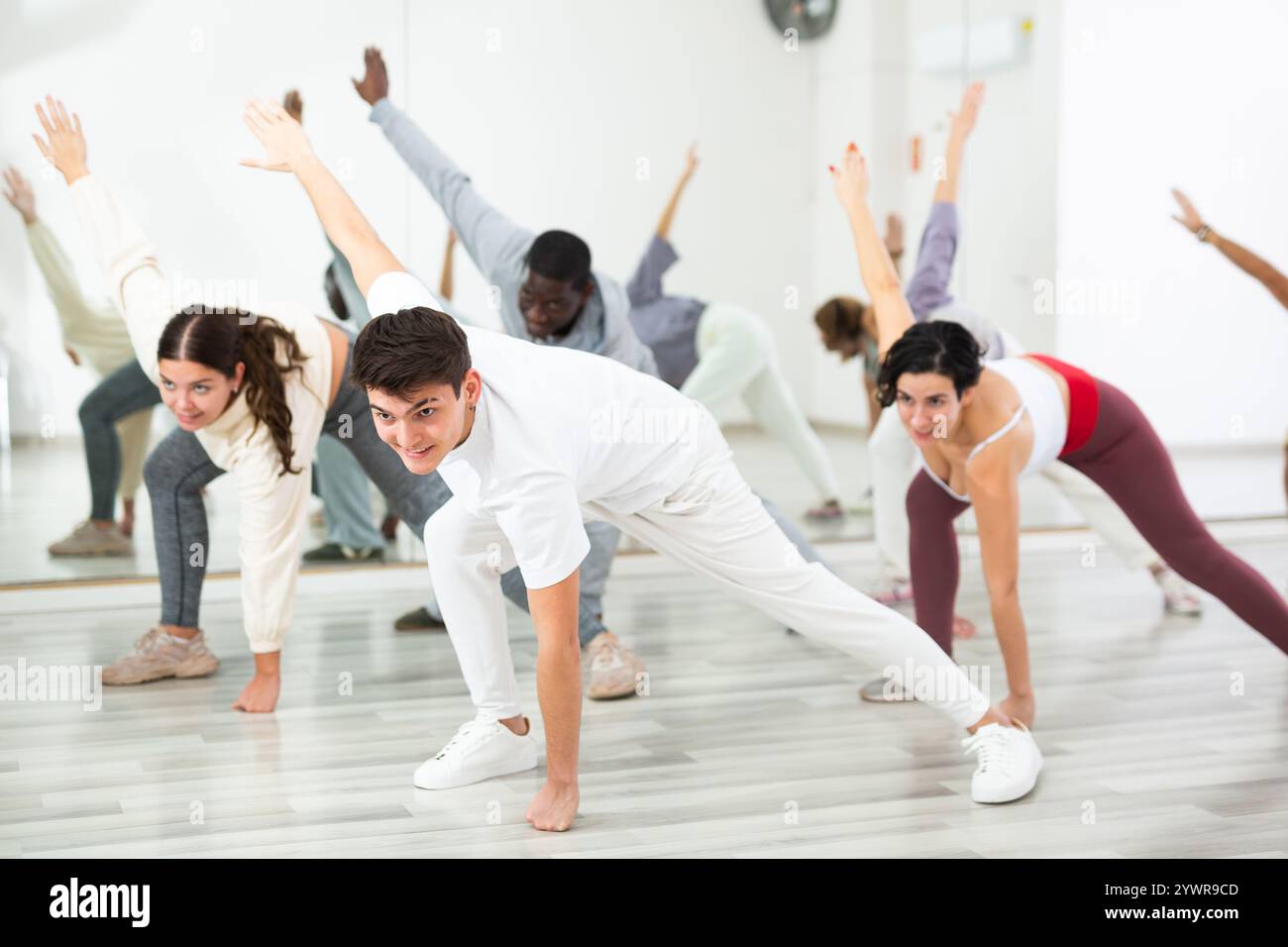 Group of active people performing a stretching exercise Stock Photo - Alamy