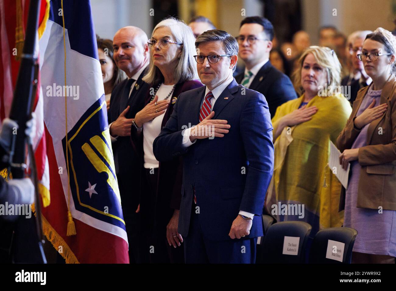Speaker Mike Johnson (R-LA) stands for the National Anthem, during the ...