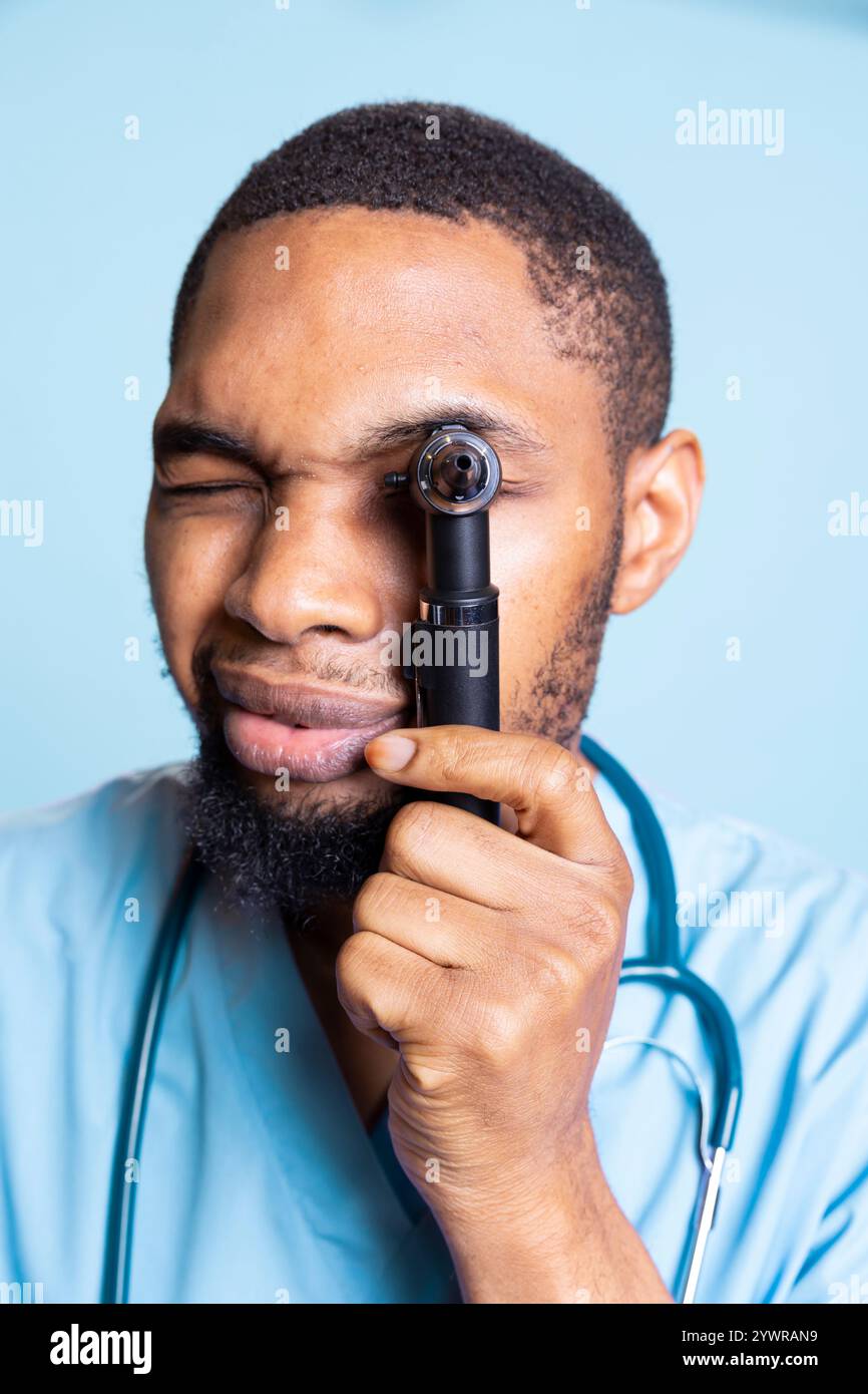 Nurse specialist does an ear drum examination to check the ear canal ...