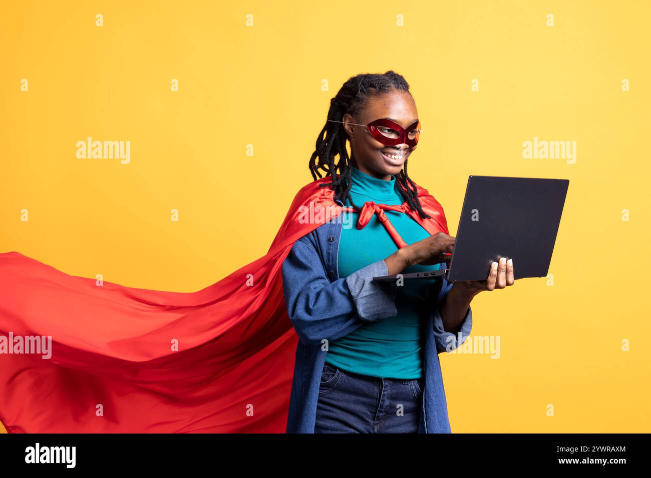 Smiling african american girl portraying superhero hiding identity ...