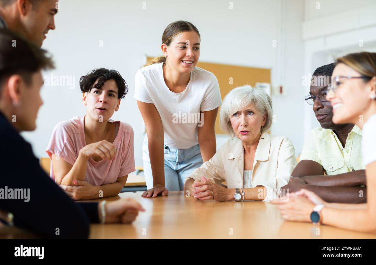 Young girl participating in Spanish language speaking club with group ...