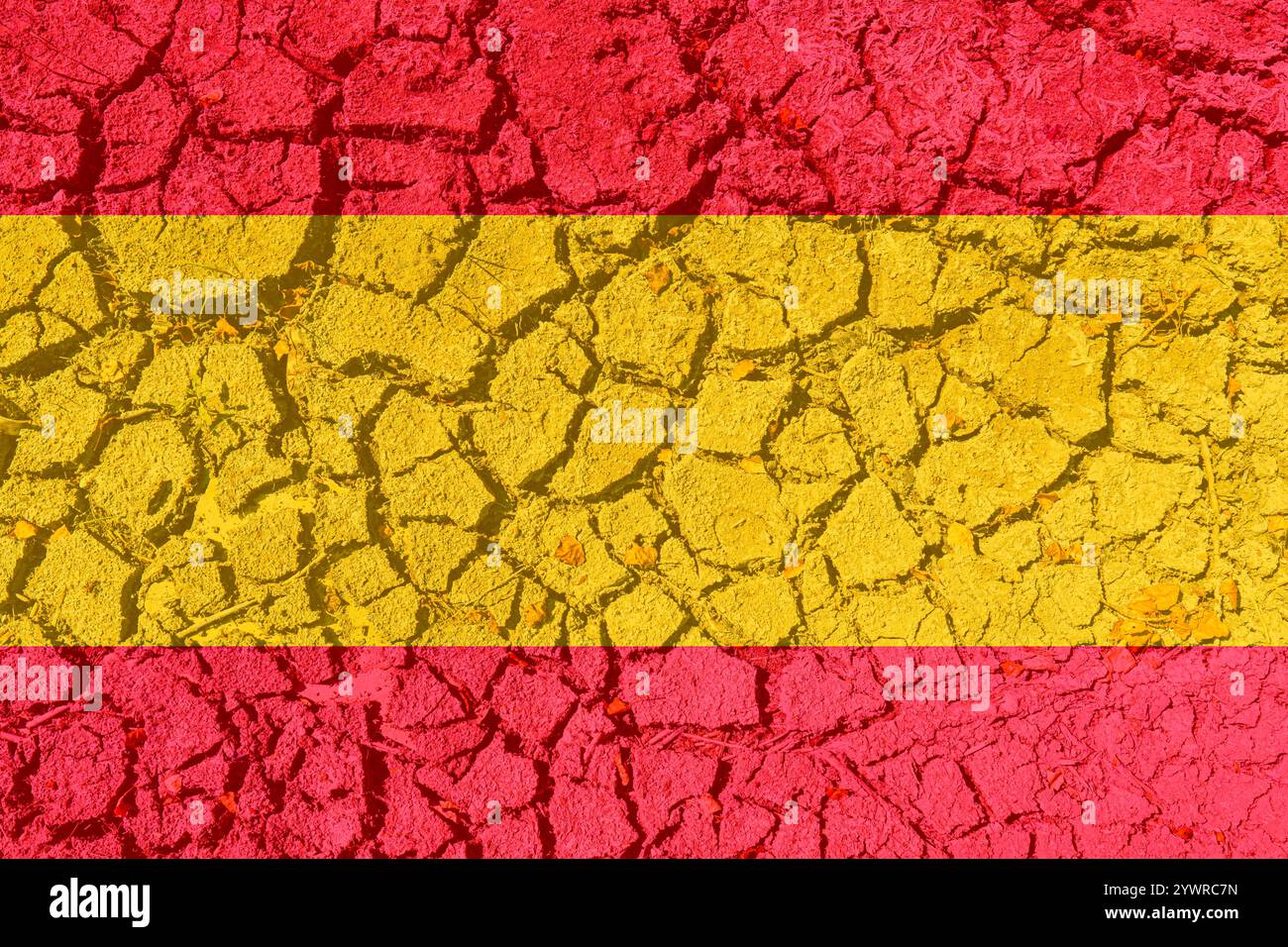 Cracked clay lake bed with Spanish flag painted on it (close-up ...