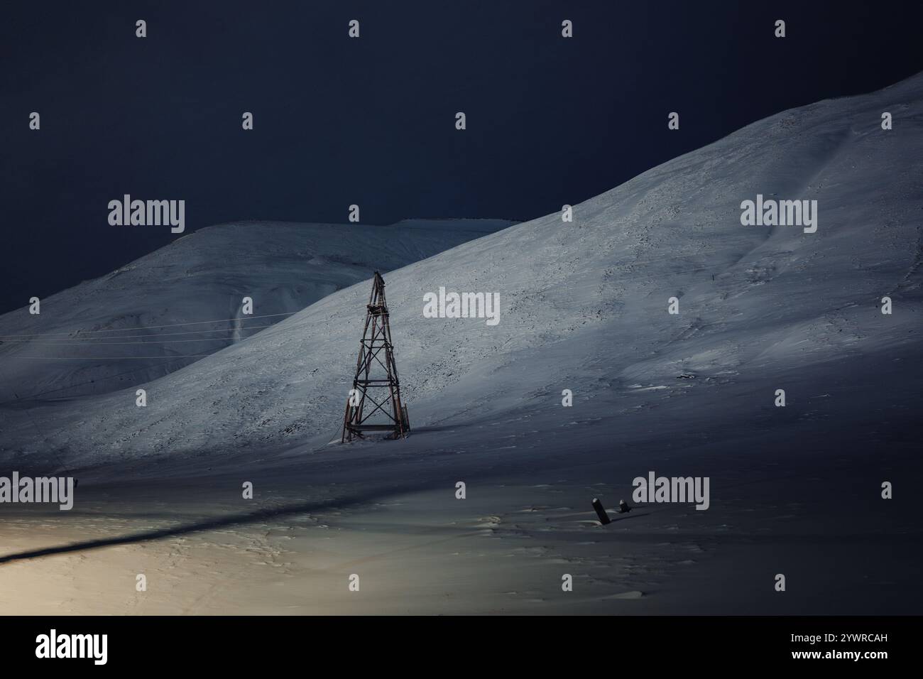 Aerial tramway wooden tower in the snow on mountain in Longyearbyen ...
