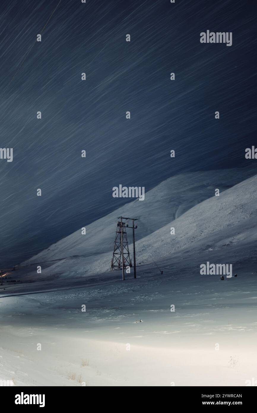 Snowing on aerial tramway tower on mountain in Longyearbyen, Svalbard ...