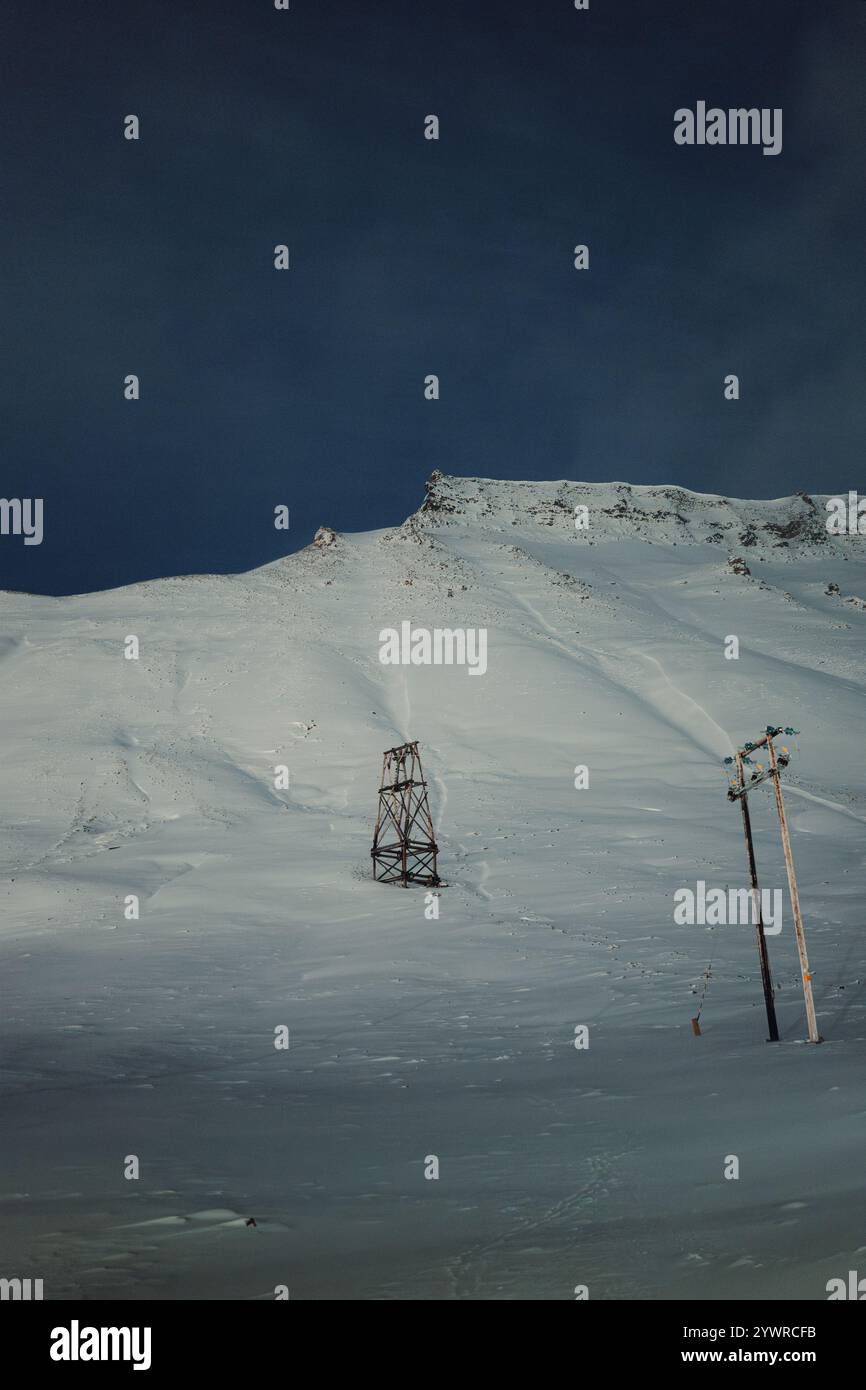 Aerial cableway wooden tower in the snow on mountain in Longyearbyen ...