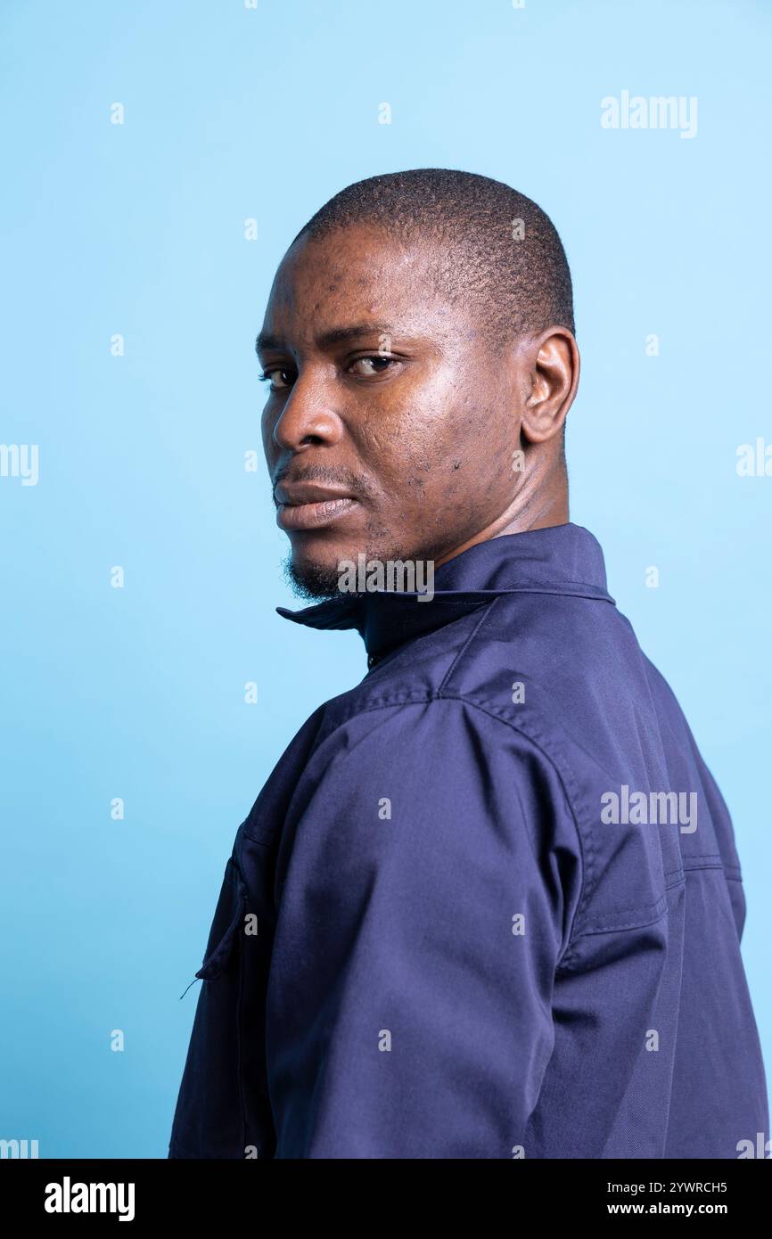 Portrait of african american security guard looking over his shoulder ...