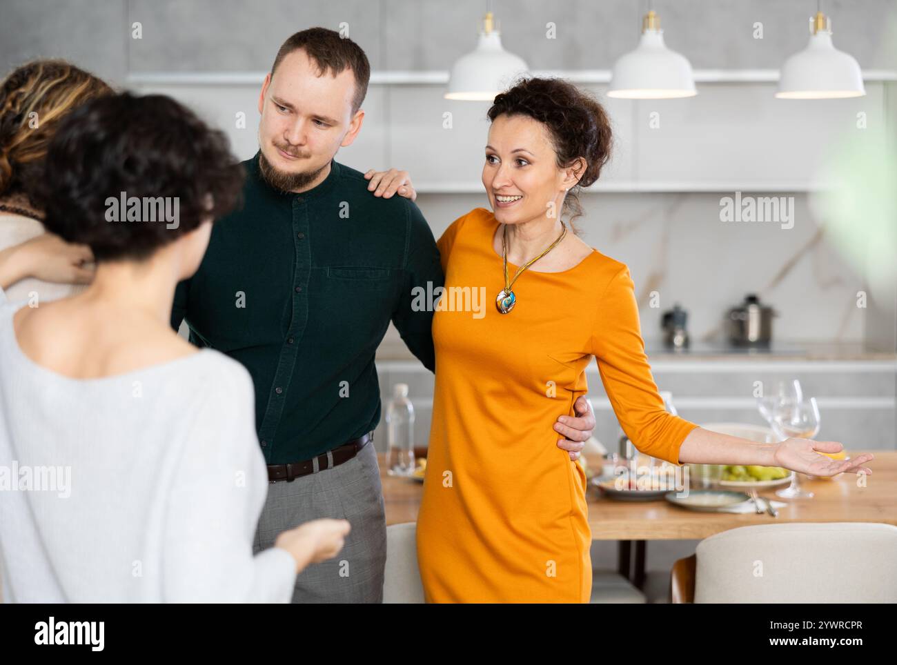 Husband and wife stand side by side and say goodbye to guests Stock ...