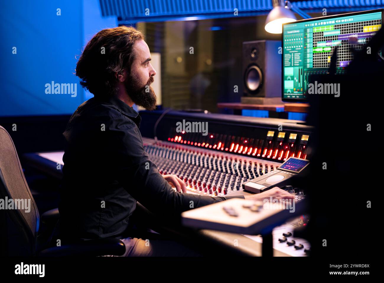 Audio engineer operating pc software for mixing and mastering tracks in ...