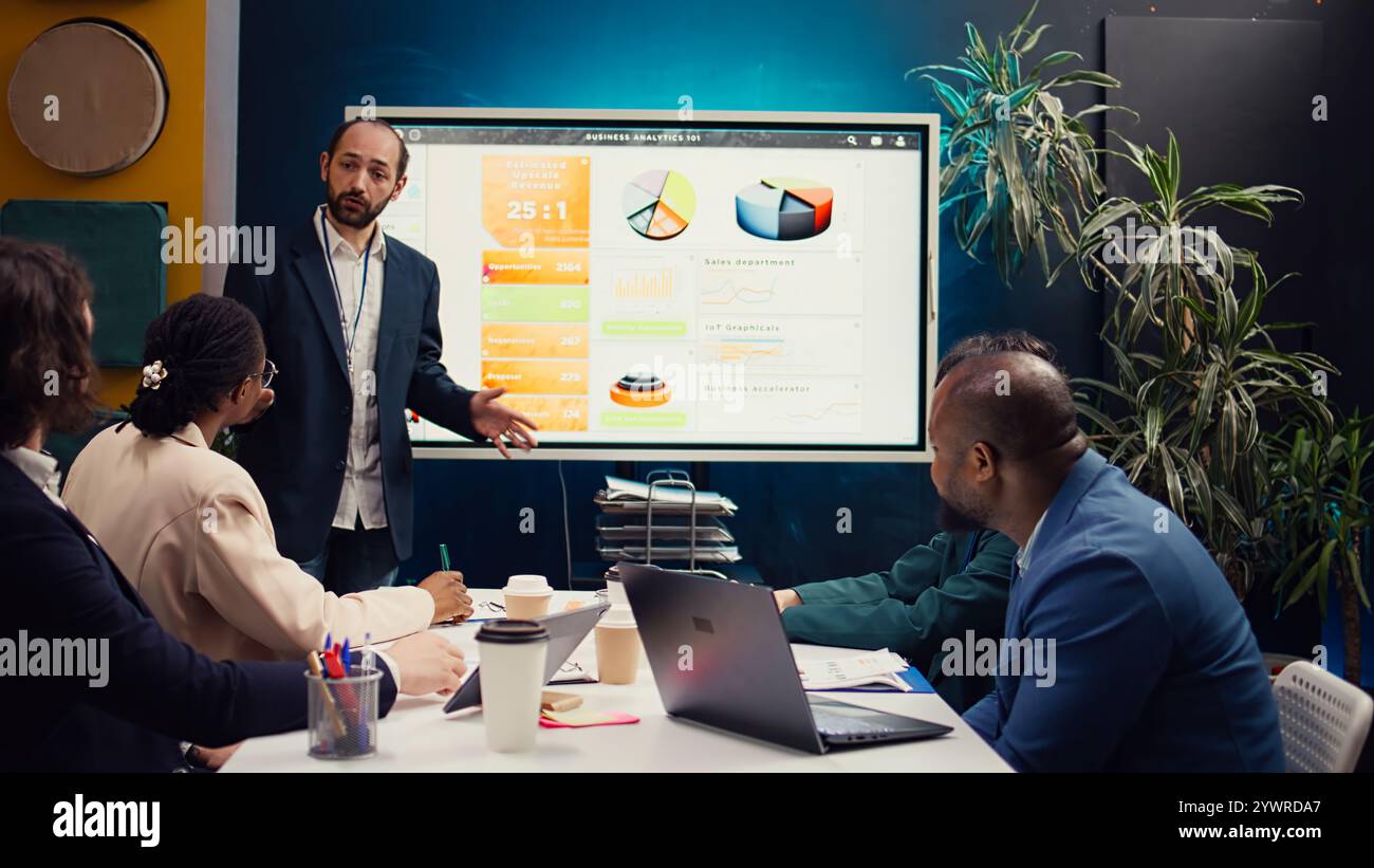 Management consultant gathering his employees for a status update ...