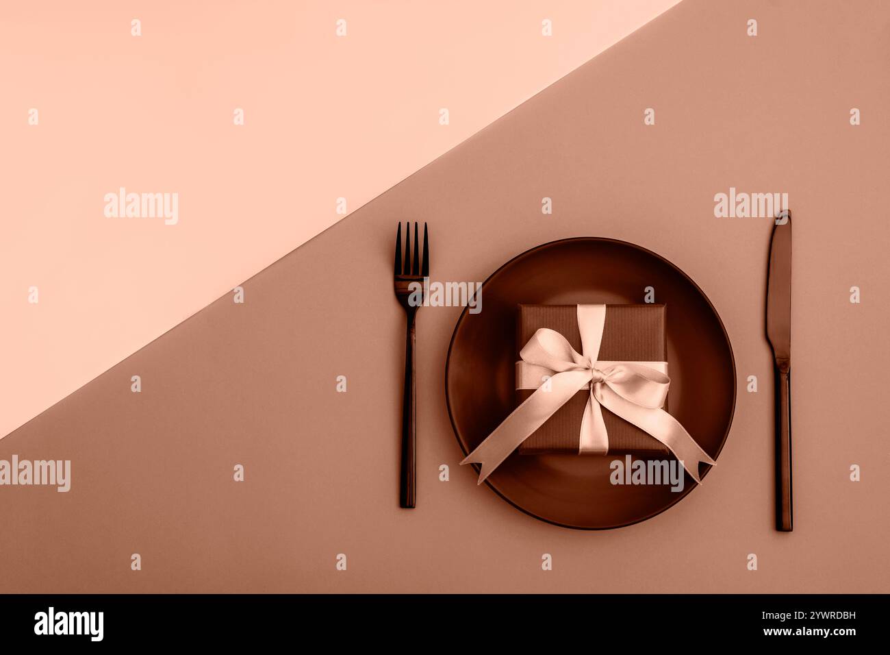 Stylish table setting, gift box, plate, cutlery on Mocha Mousse colored ...