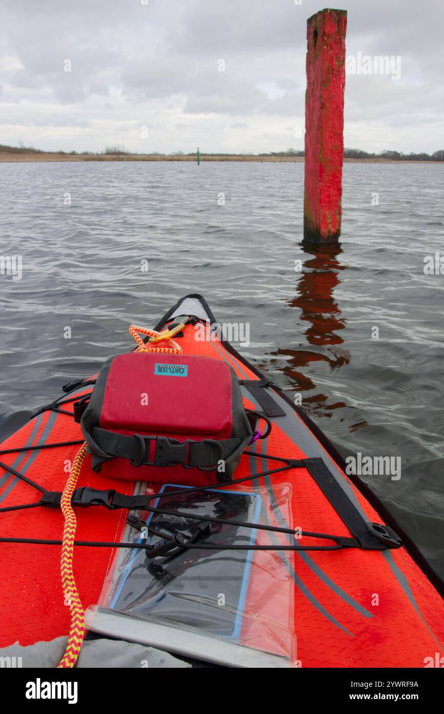 Channel marker post seen in the placid waters of Barton Broad, Norfolk ...