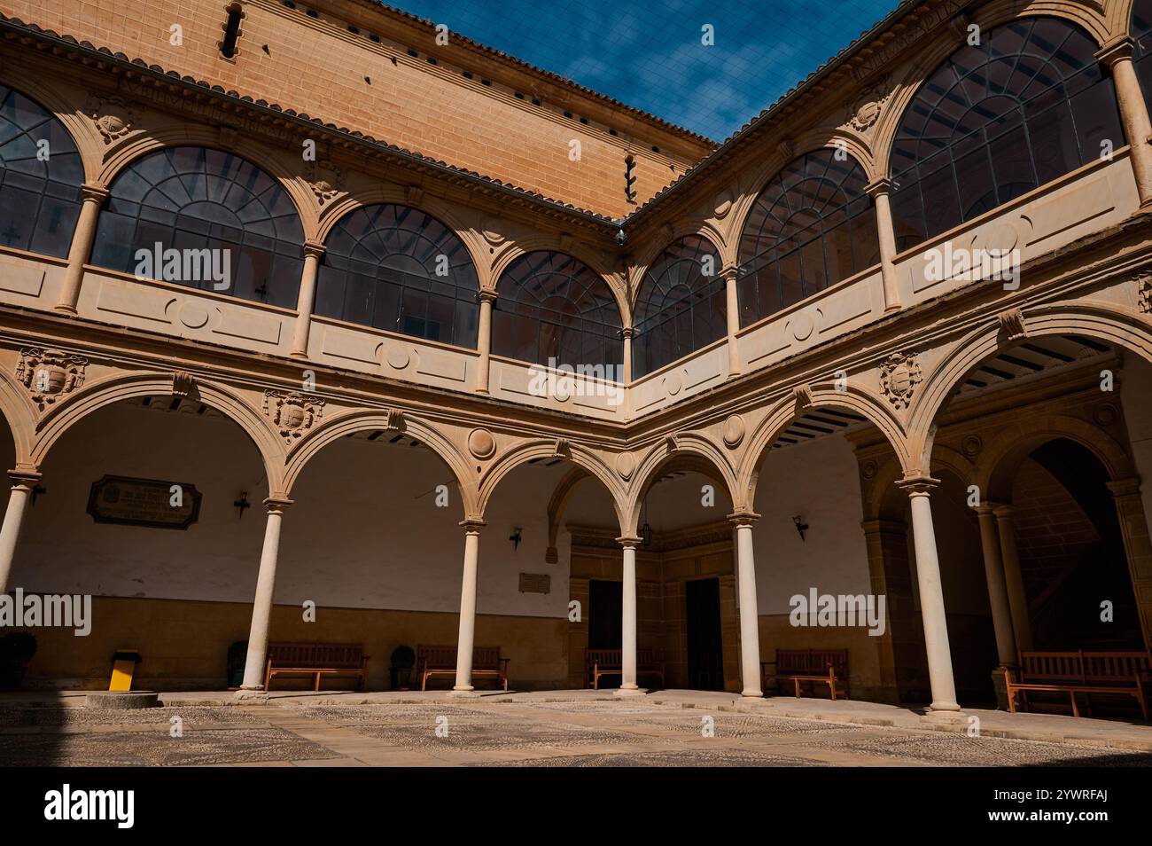 A beautiful historical courtyard featuring elegant arches and warm ...