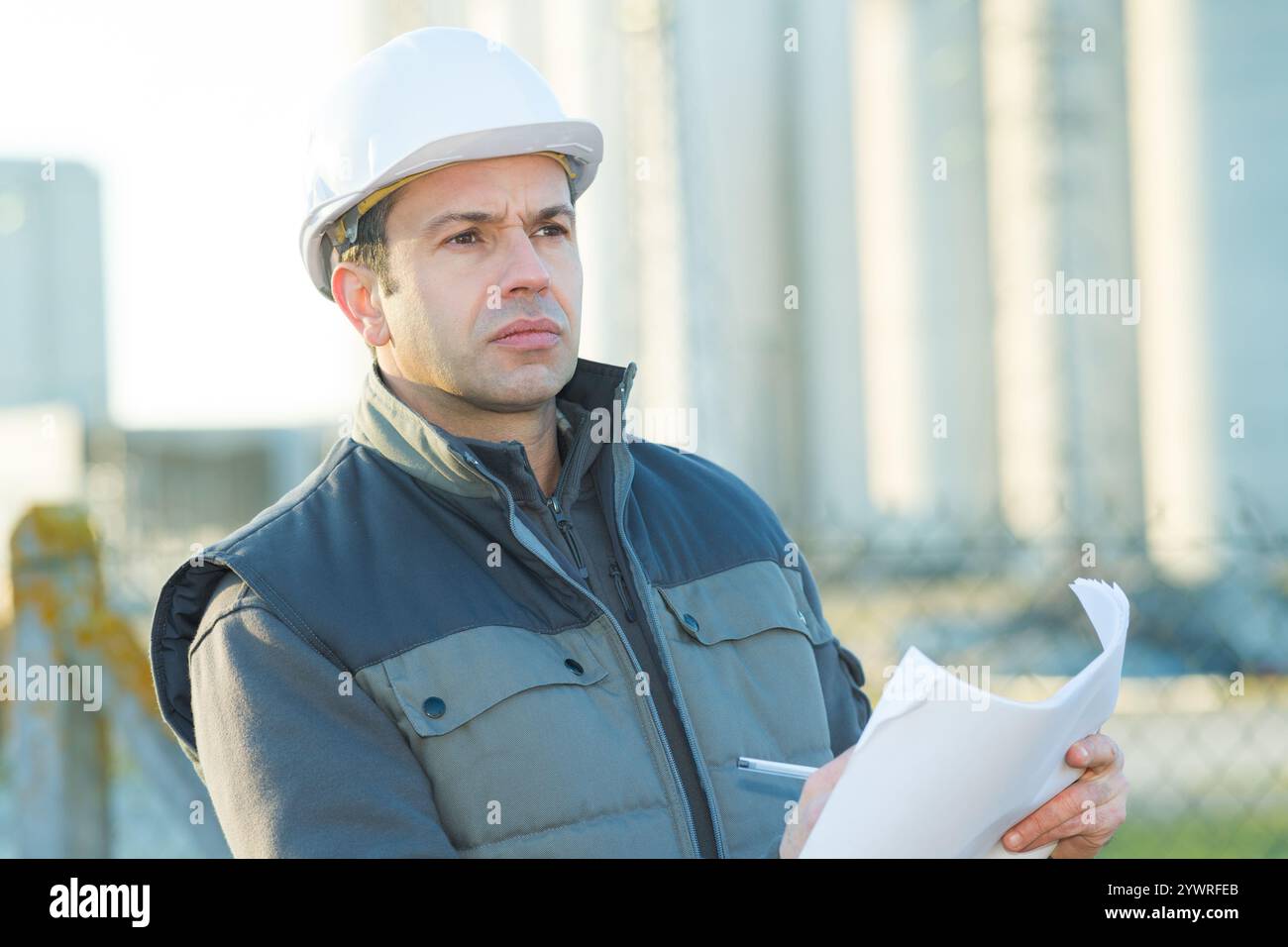 male architect reading architectural project Stock Photo - Alamy