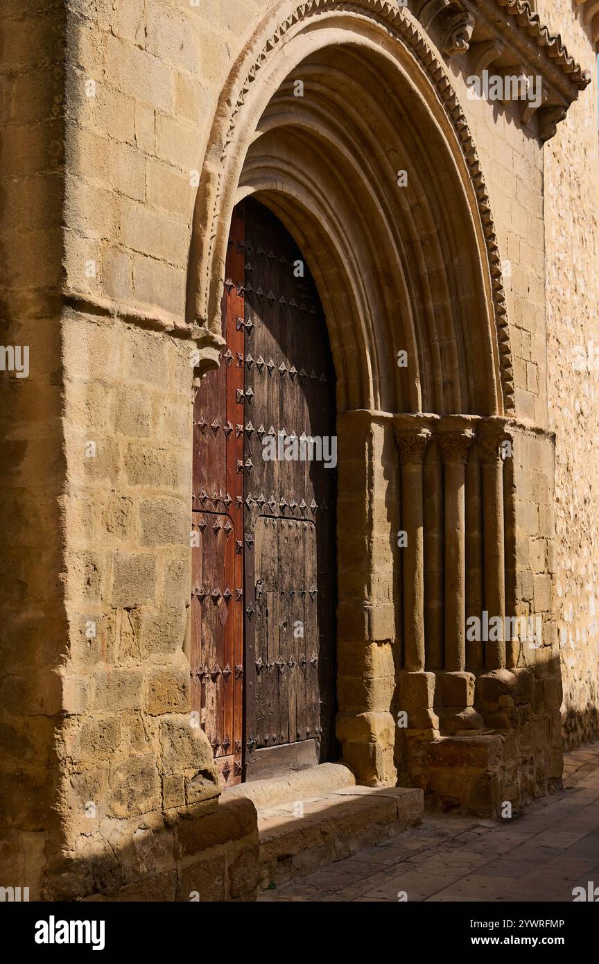 A beautifully preserved stone archway with an ornate wooden door ...