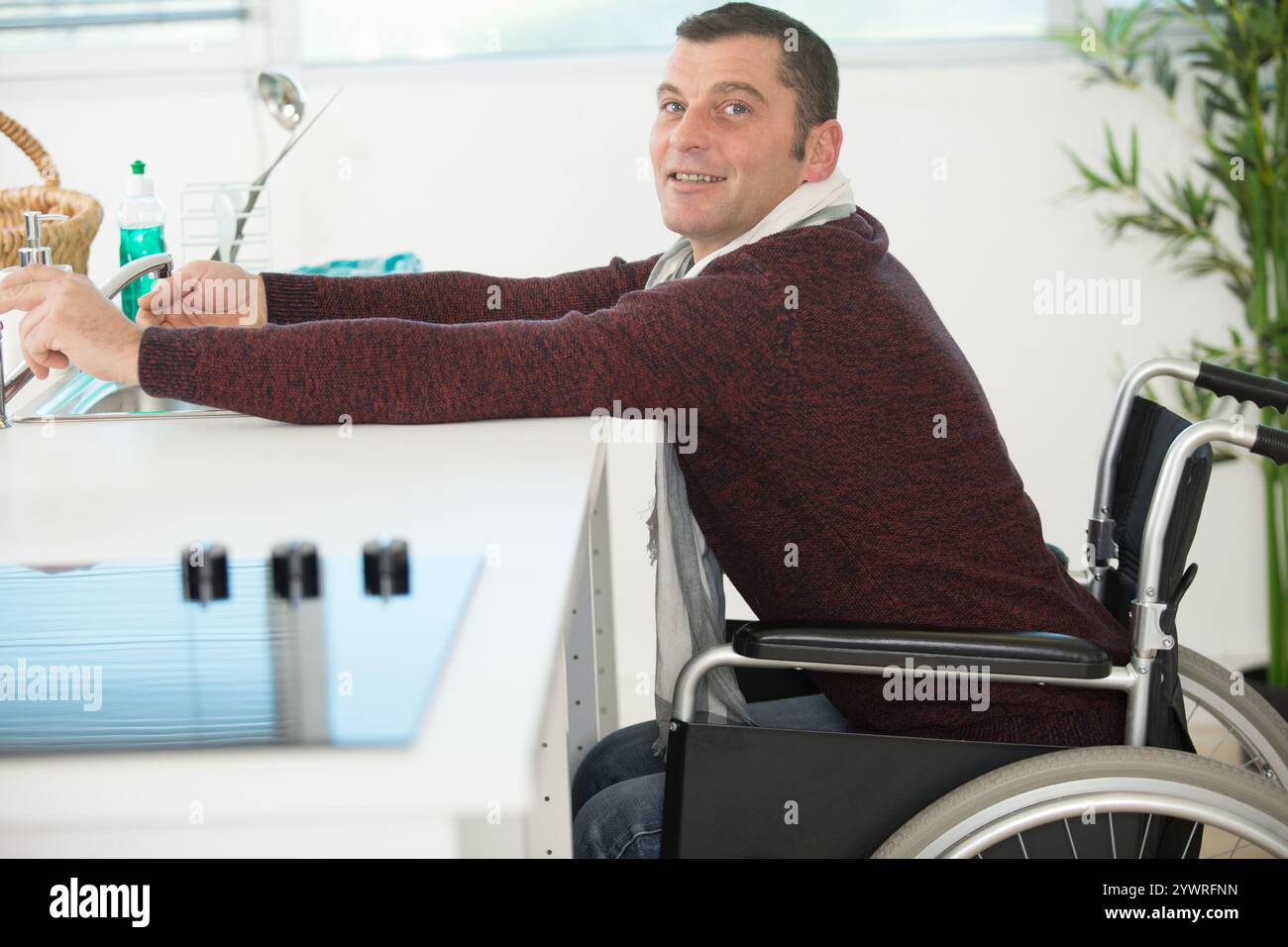 happy disabled man sitting on wheelchair arranging plates Stock Photo ...