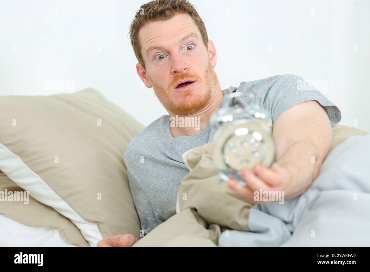 Shocked young man alarm hi-res stock photography and images - Alamy