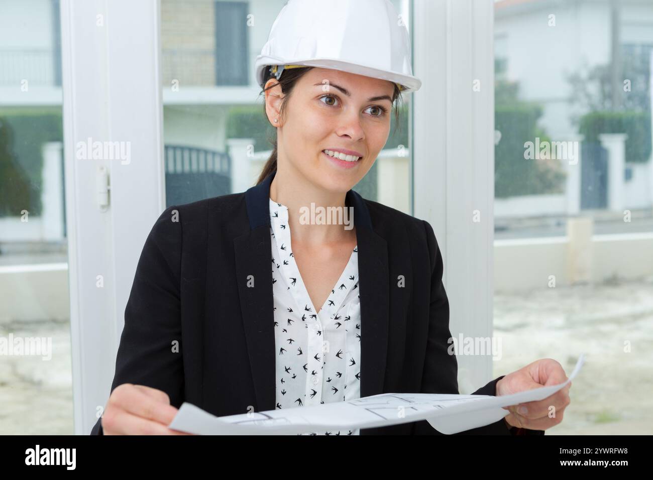 young female construction specialist reviewing blueprints at construction site Stock Photo - Alamy