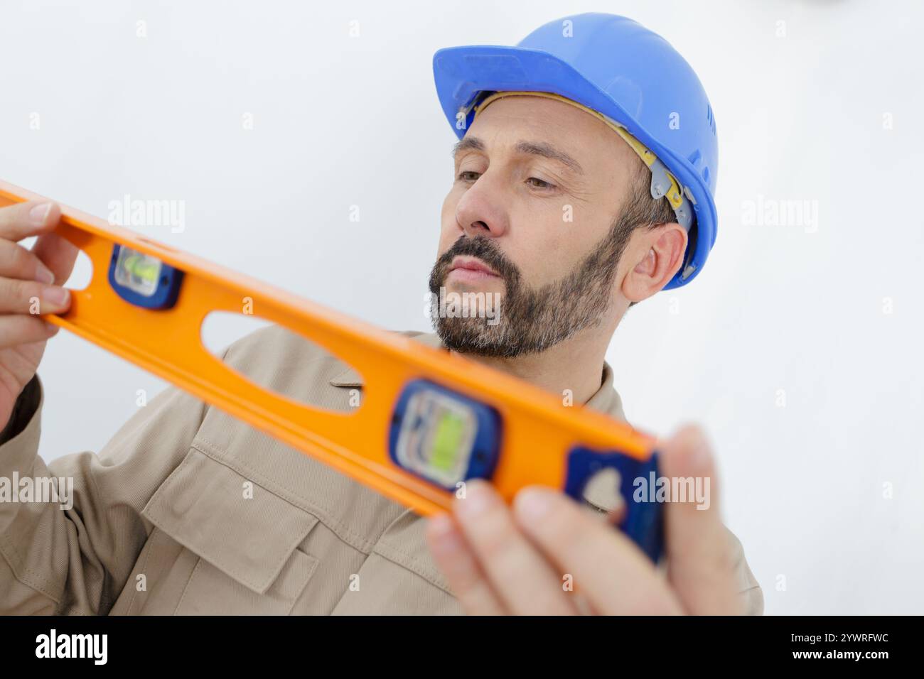 a male builder measuring a wall Stock Photo - Alamy