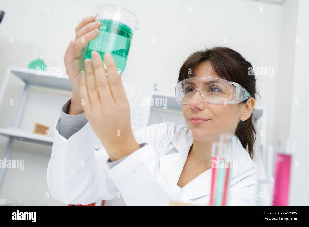 female lab worker holding flask Stock Photo - Alamy